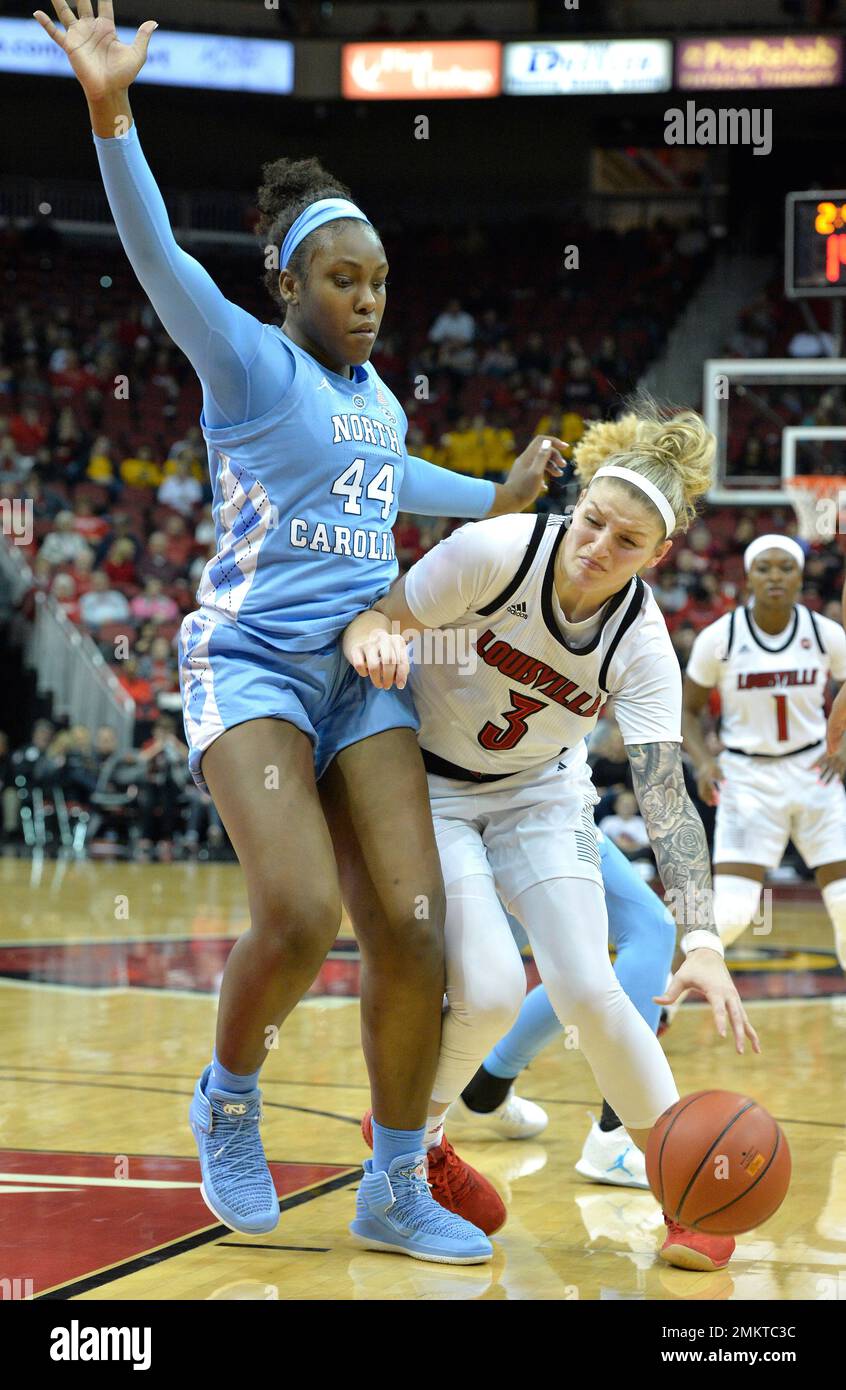 Louisville forward Sam Fuehring (3) attempts to get around the defense ...