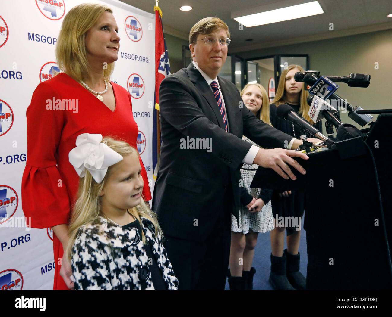 Flanked by his wife, Elee Reeves, second from left, daughters Maddie ...