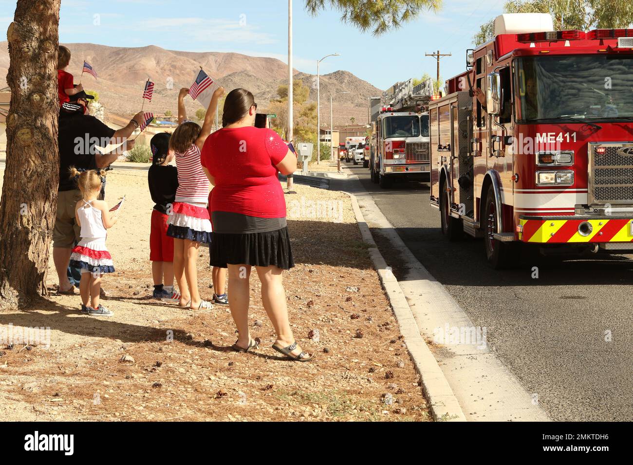 Fort Irwin community members lined the streets to wave flags and show ...