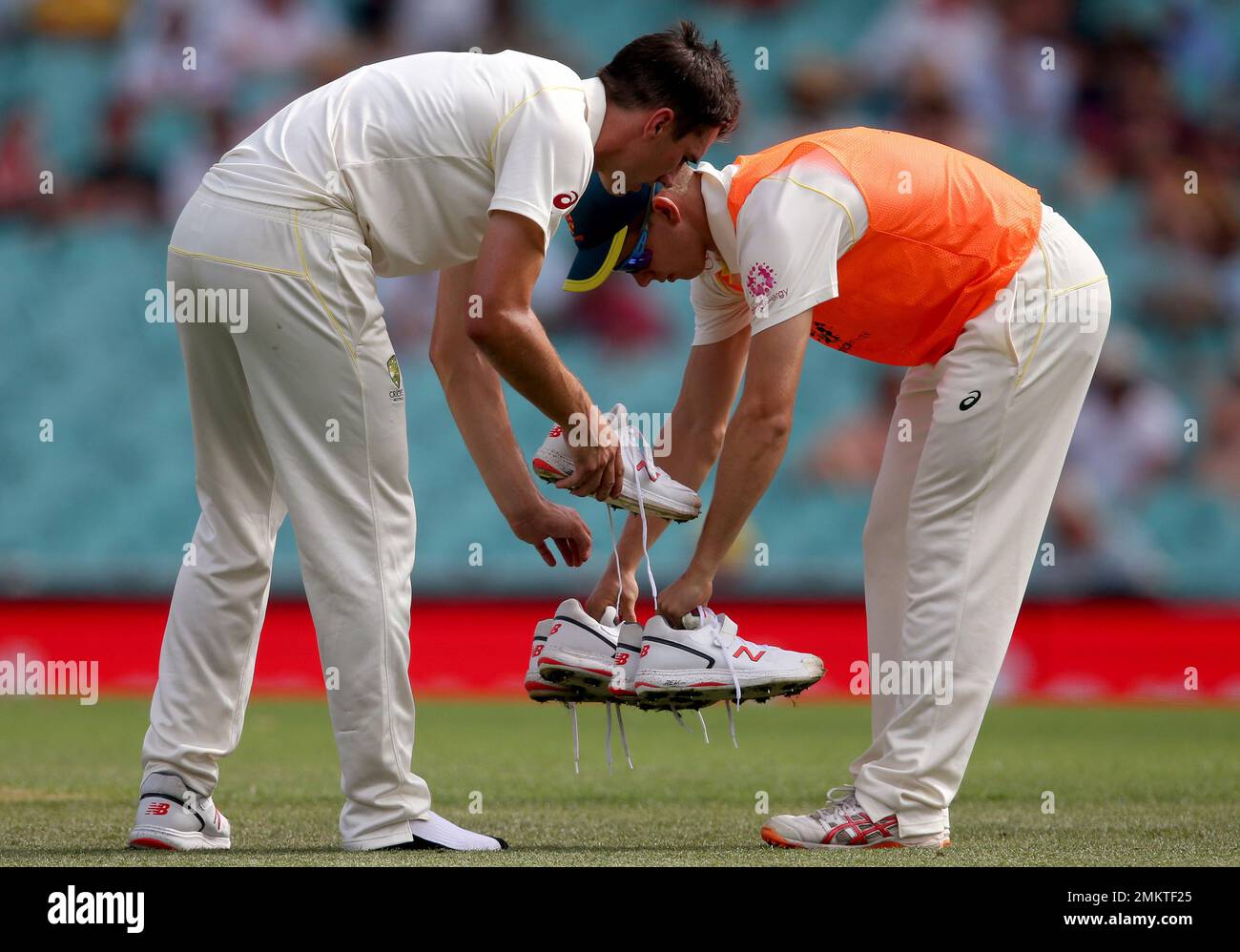 Australia's Pat Cummins, left, replaces a shoe during their cricket ...