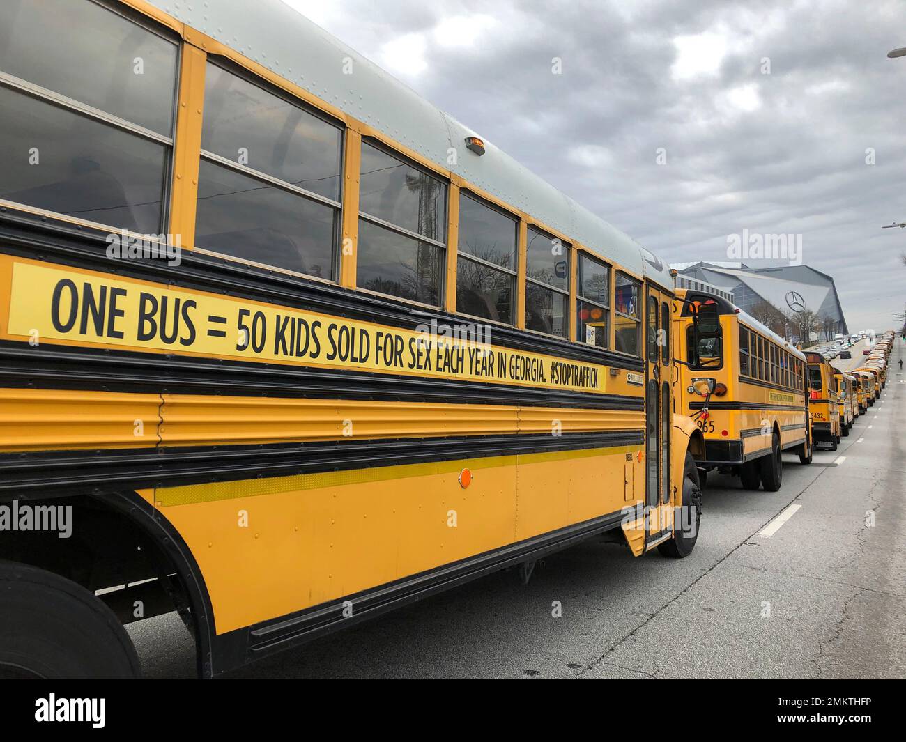 A line of school buses with new decals to draw attention to human ...
