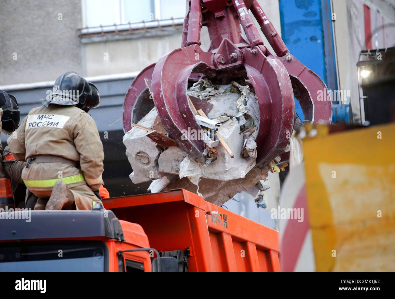 Emergency Situations employees look at debris of damaged parts of a ...