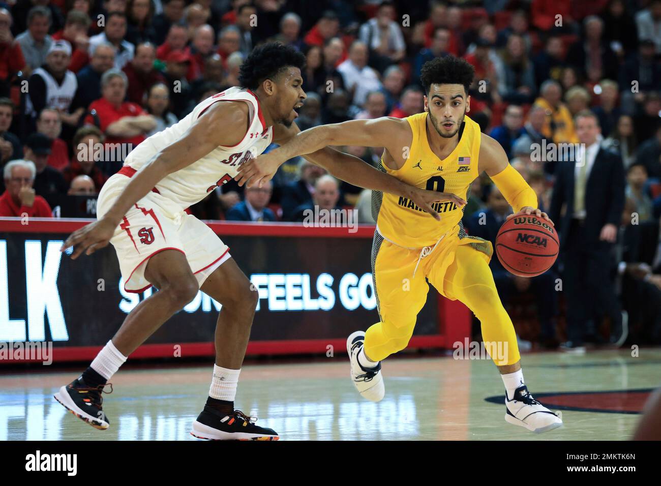 Marquette guard Markus Howard drives past St. John's guard Justin Simon ...