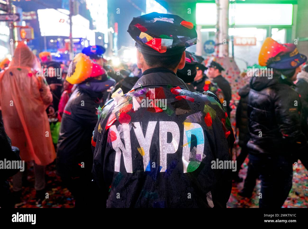 A New York City police officer is covered with confetti in Times Square ...