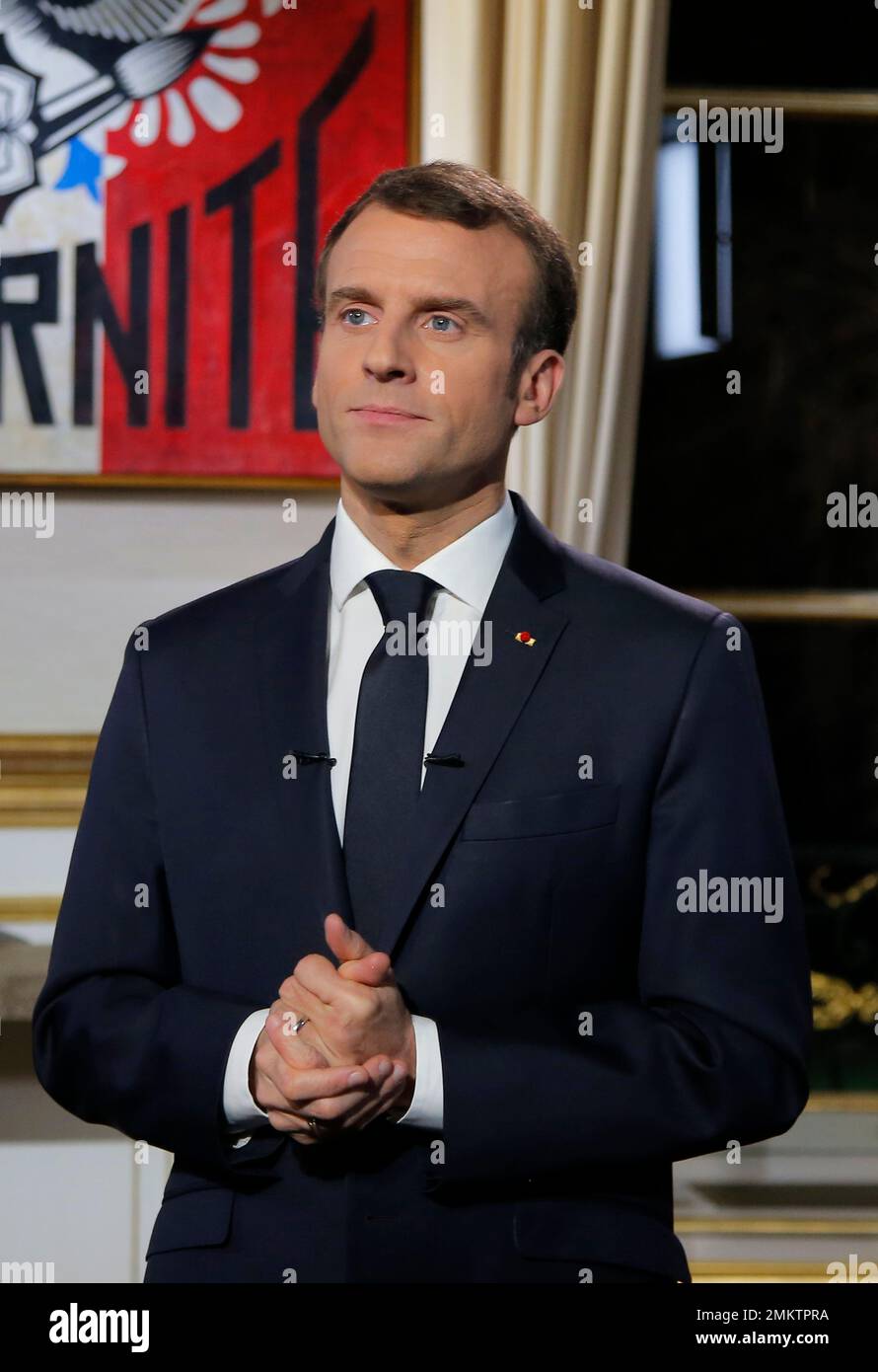French President Emmanuel Macron, gestures as he poses for a photograph ...