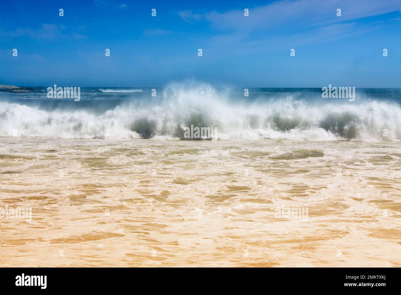 Strong waves crash over the beach Stock Photo - Alamy