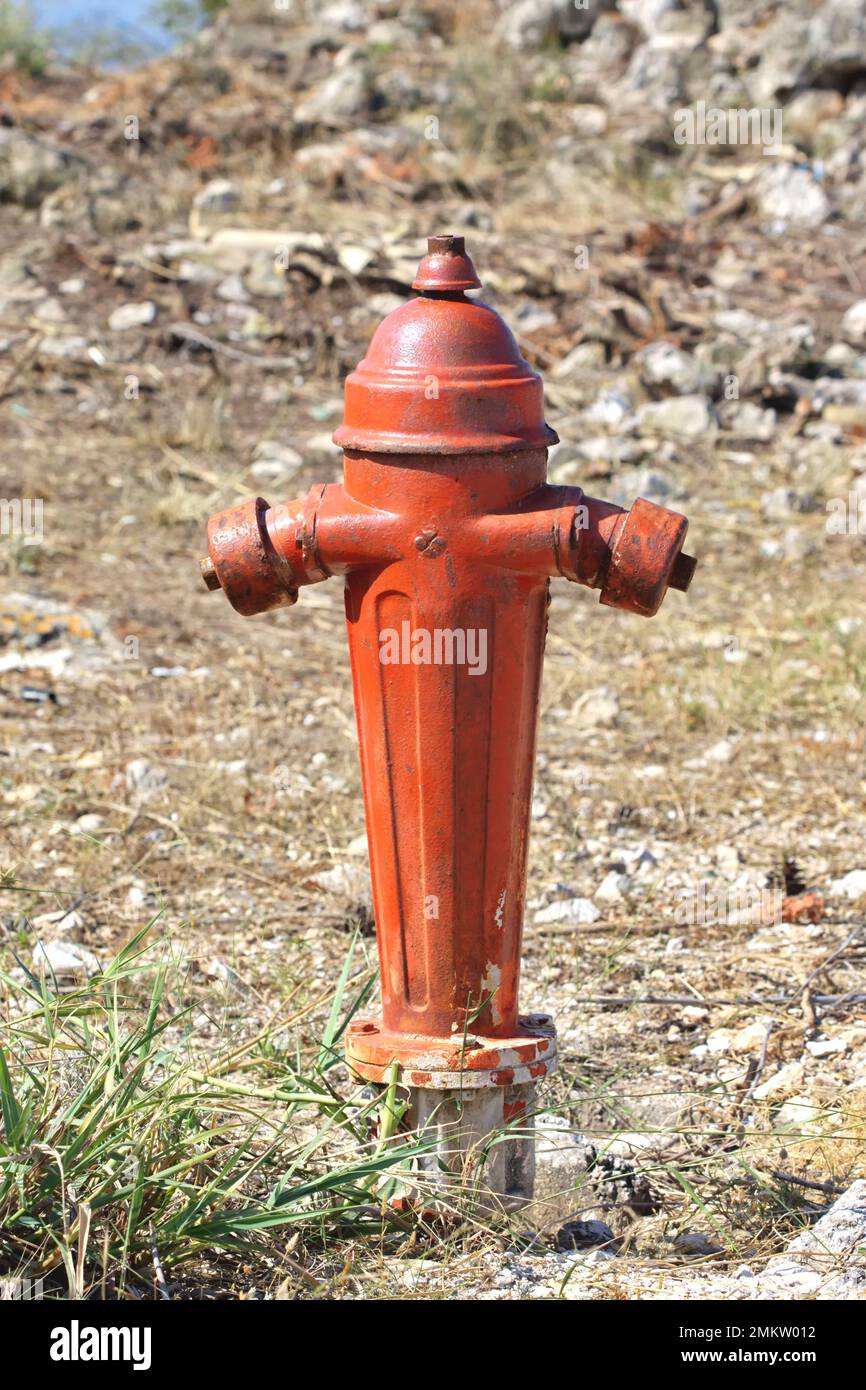 typical red fire hydrant in the ground Stock Photo - Alamy
