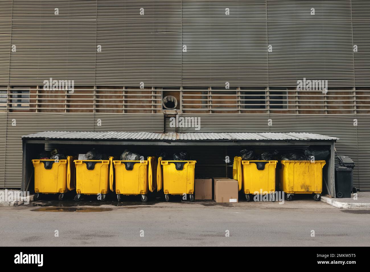 Yellow trash containers on a city street against the background of a ...