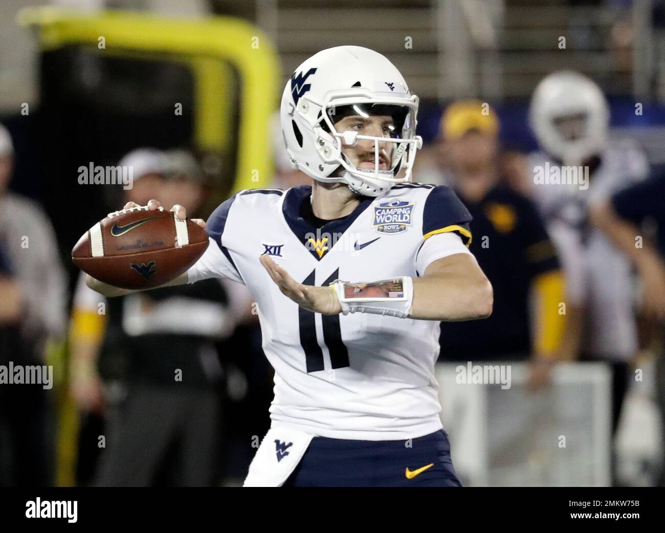 West Virginia quarterback Jack Allison looks for a receiver during the ...
