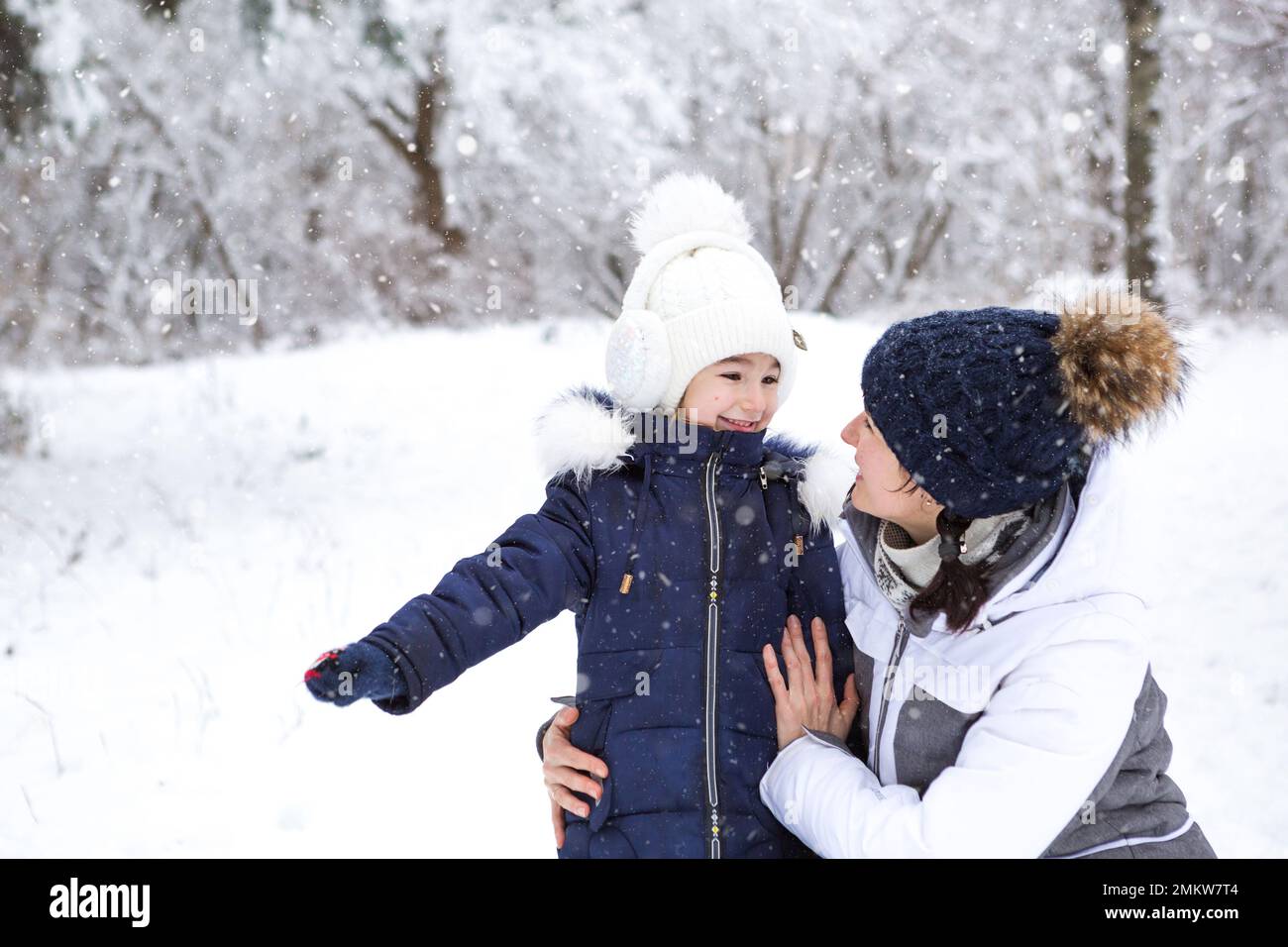 Mom and daughter hugging, looking at each other with love, on a walk ...