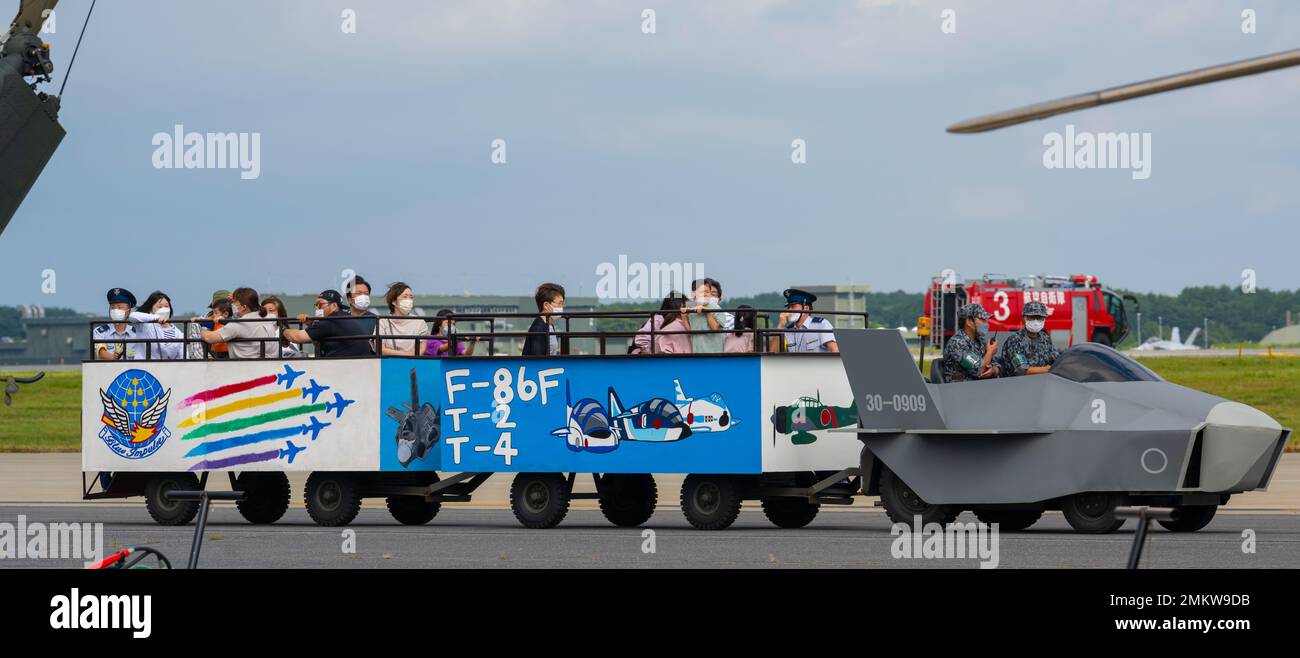 Japan Air Self-Defense Force (JASDF) members drive attendees on the ...