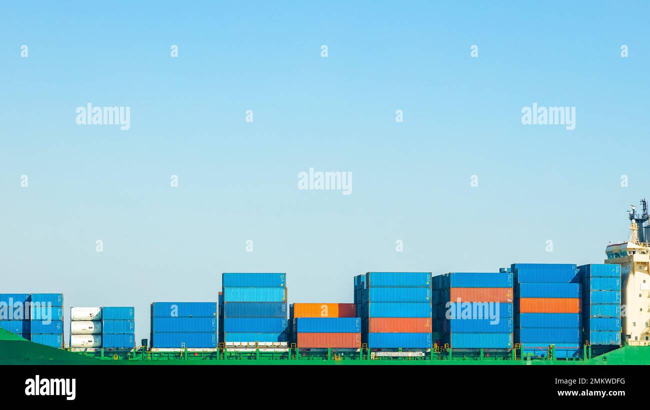 A large cargo container ship loaded with containers against the blue ...