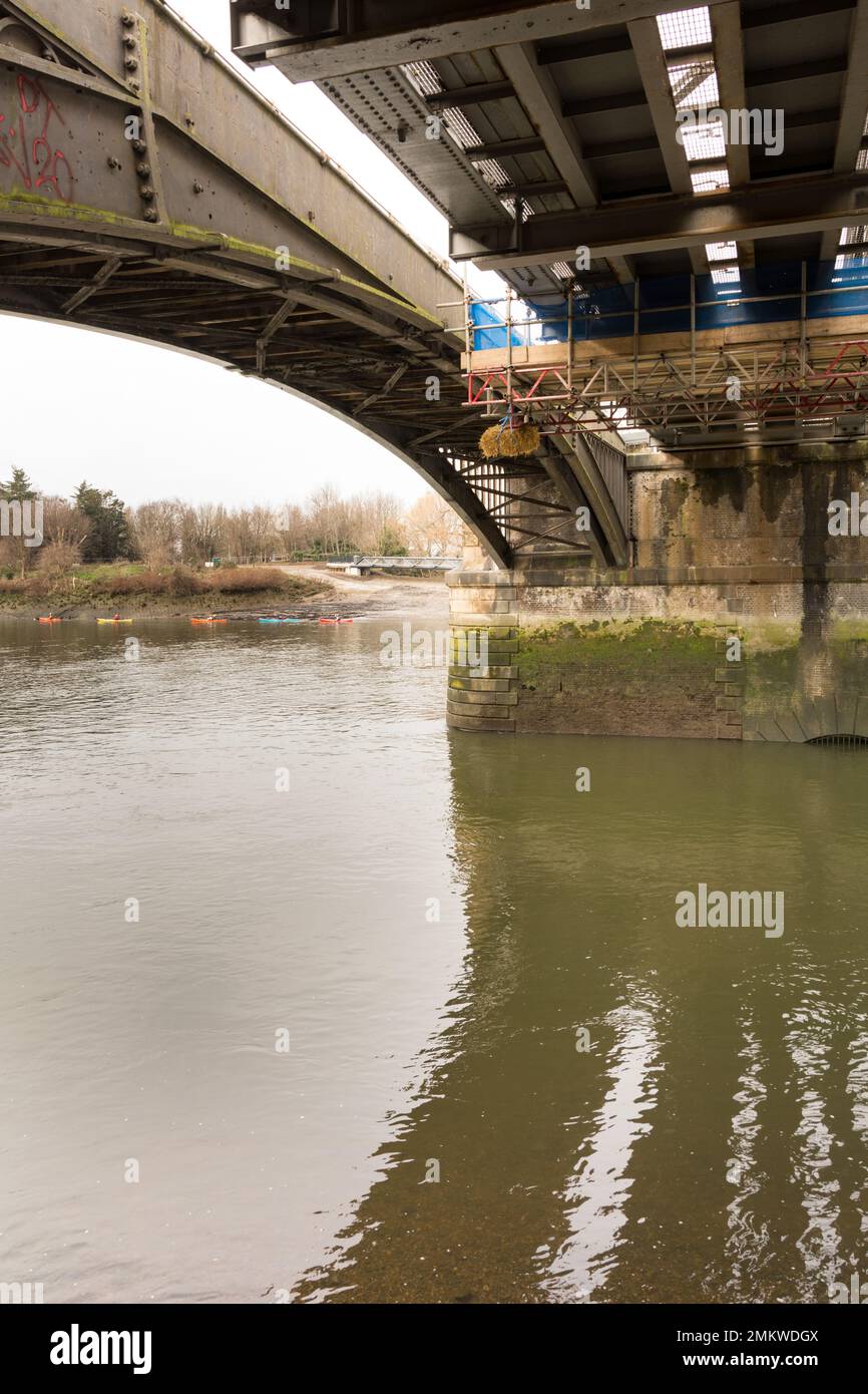 A straw bale hangs under Barnes Bridge to warn river craft of a change ...