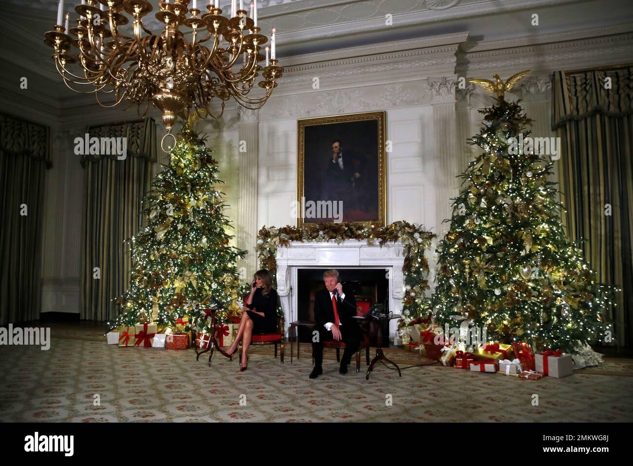 President Donald Trump chuckles as he and first lady Melania Trump each ...