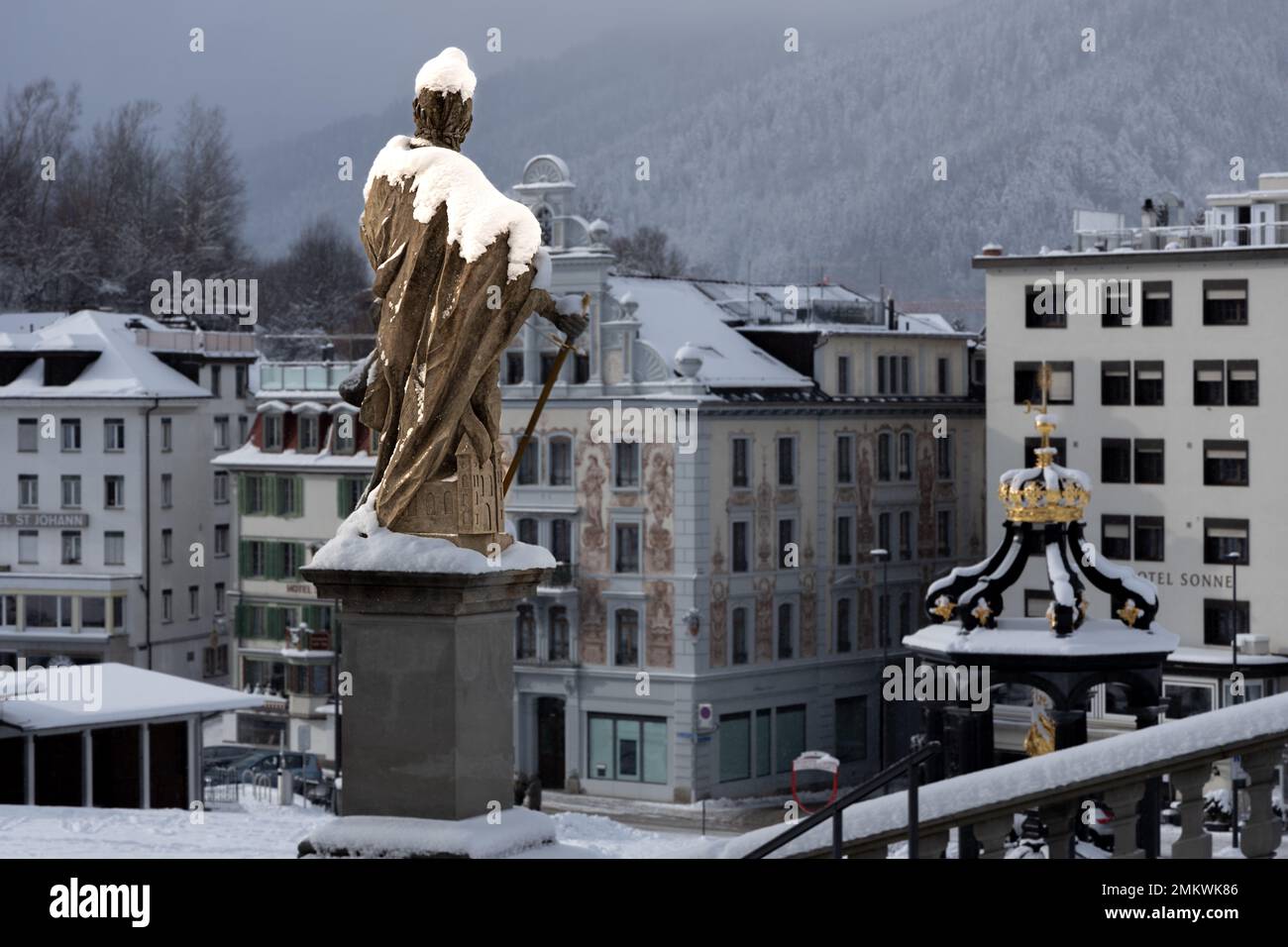 Statue of a saint, looking over the monastery courtyard in Einsiedeln ...