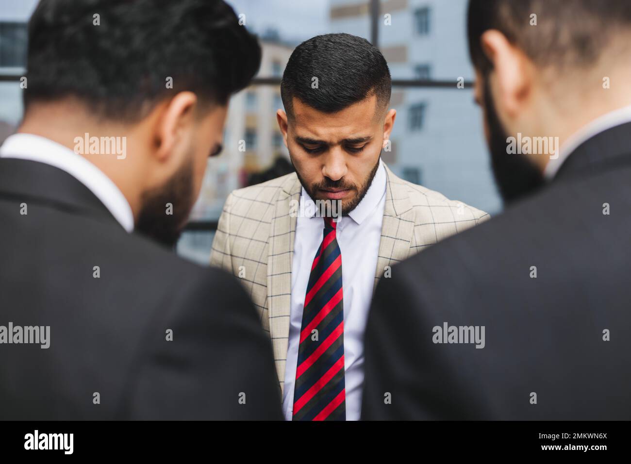 Business people outdoor meeting. Men in jackets discuss working moments ...