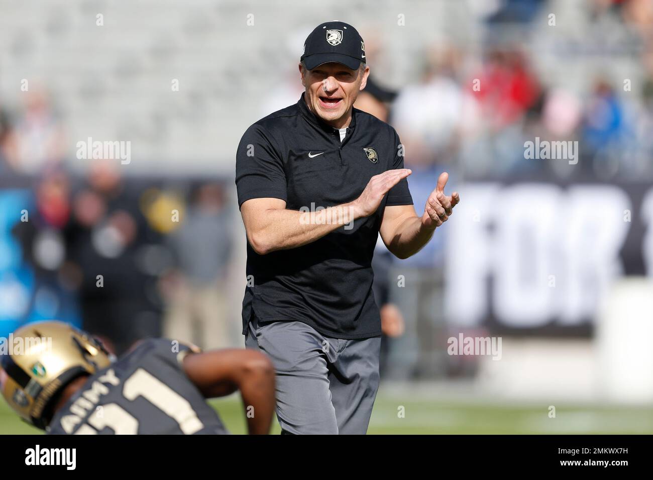 Army head coach Jeff Monken watches as his team warms up before they ...