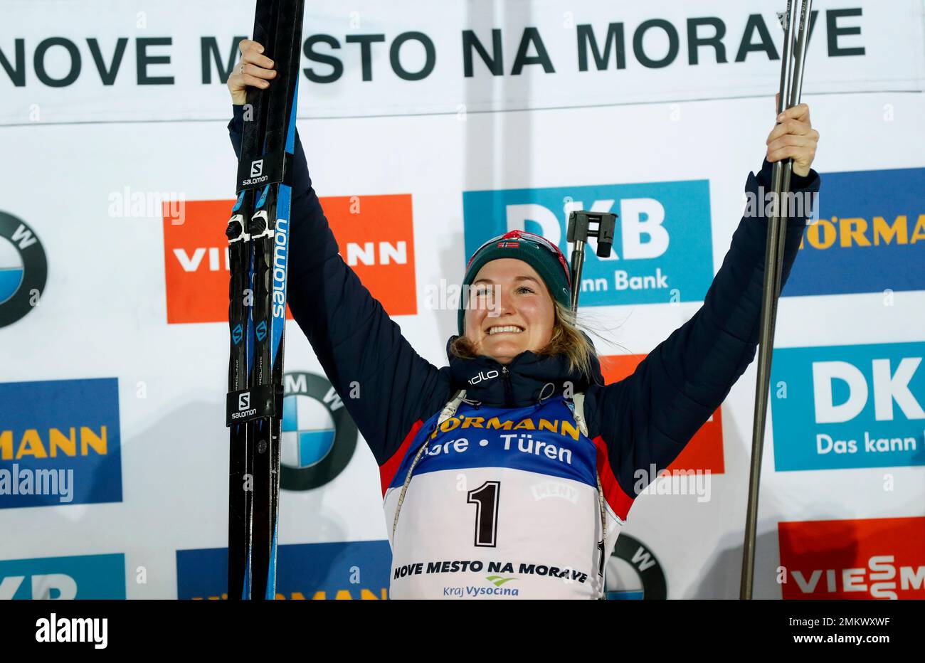 Norway's Marte Olsbu Roeiseland jubilates on the podium after taking ...