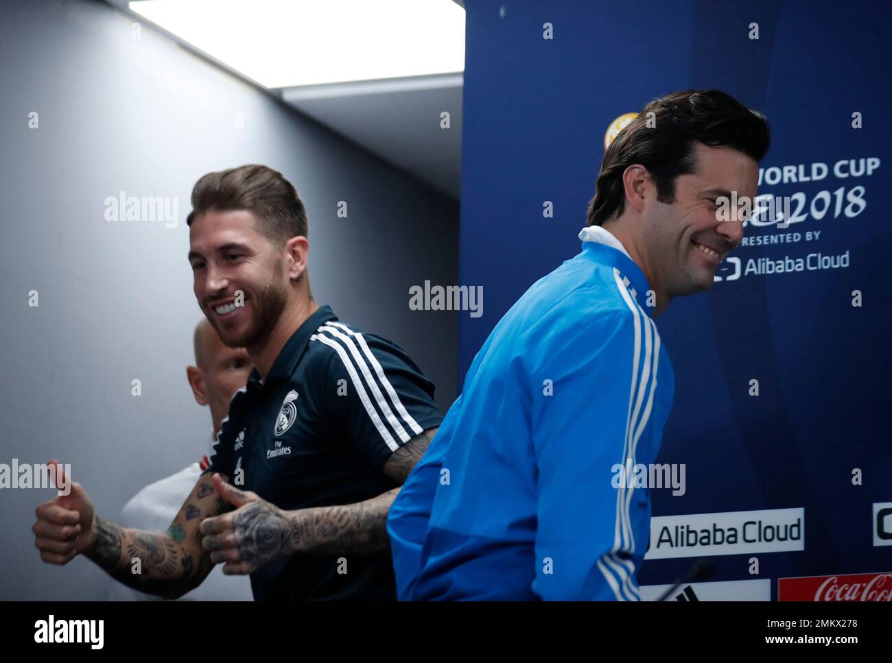 Real Madrid's defender Sergio Ramos, left, smiles while he leaves his ...