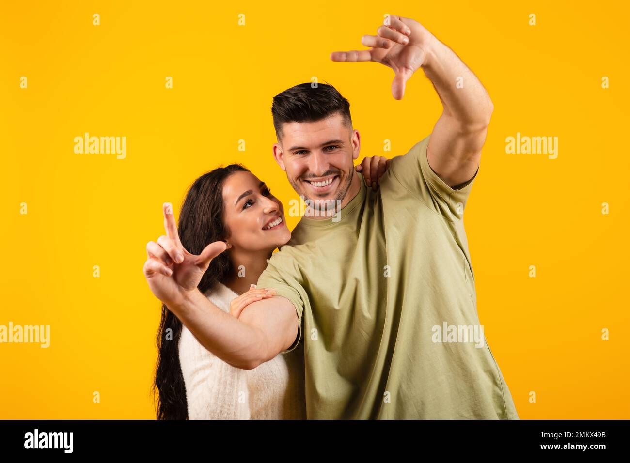 Cheerful young pretty arab woman hugging boyfriend in casual, husband ...