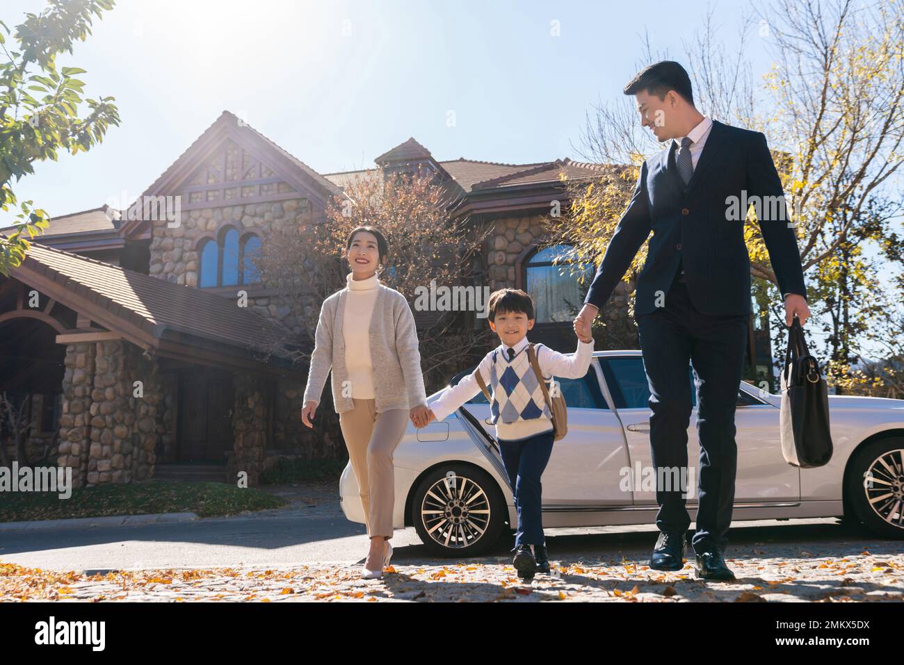 A young couple pick up the kids from school Stock Photo - Alamy
