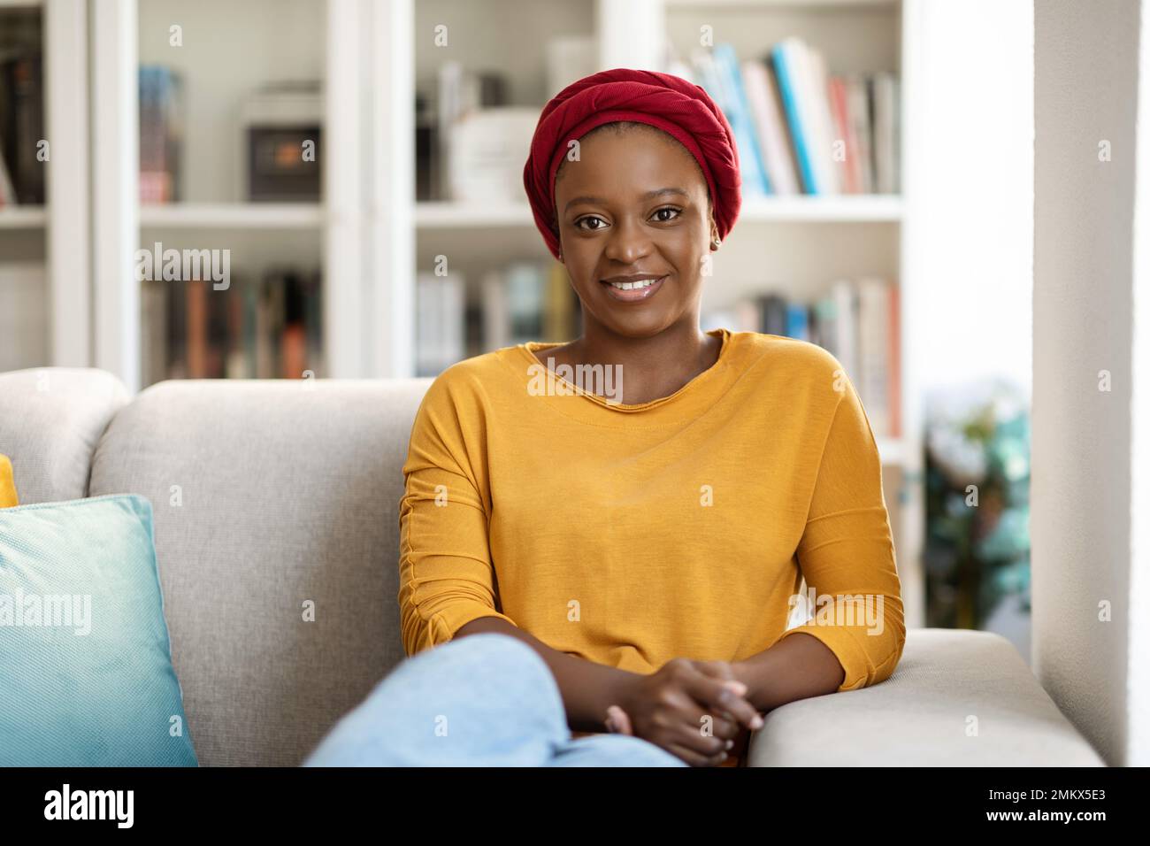 Young calm black woman relaxing on sofa in living room Stock Photo - Alamy