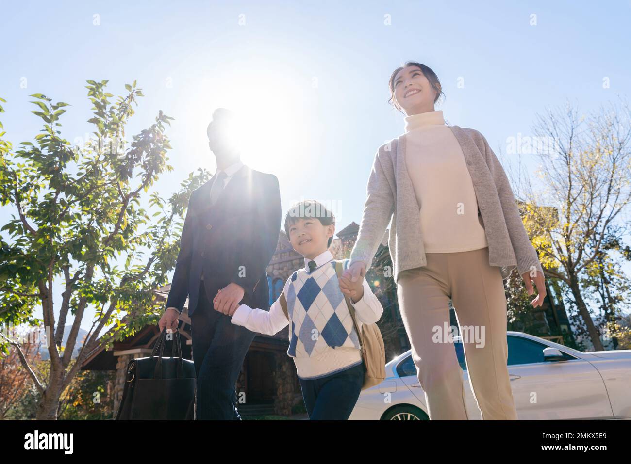 A young couple pick up the kids from school Stock Photo - Alamy