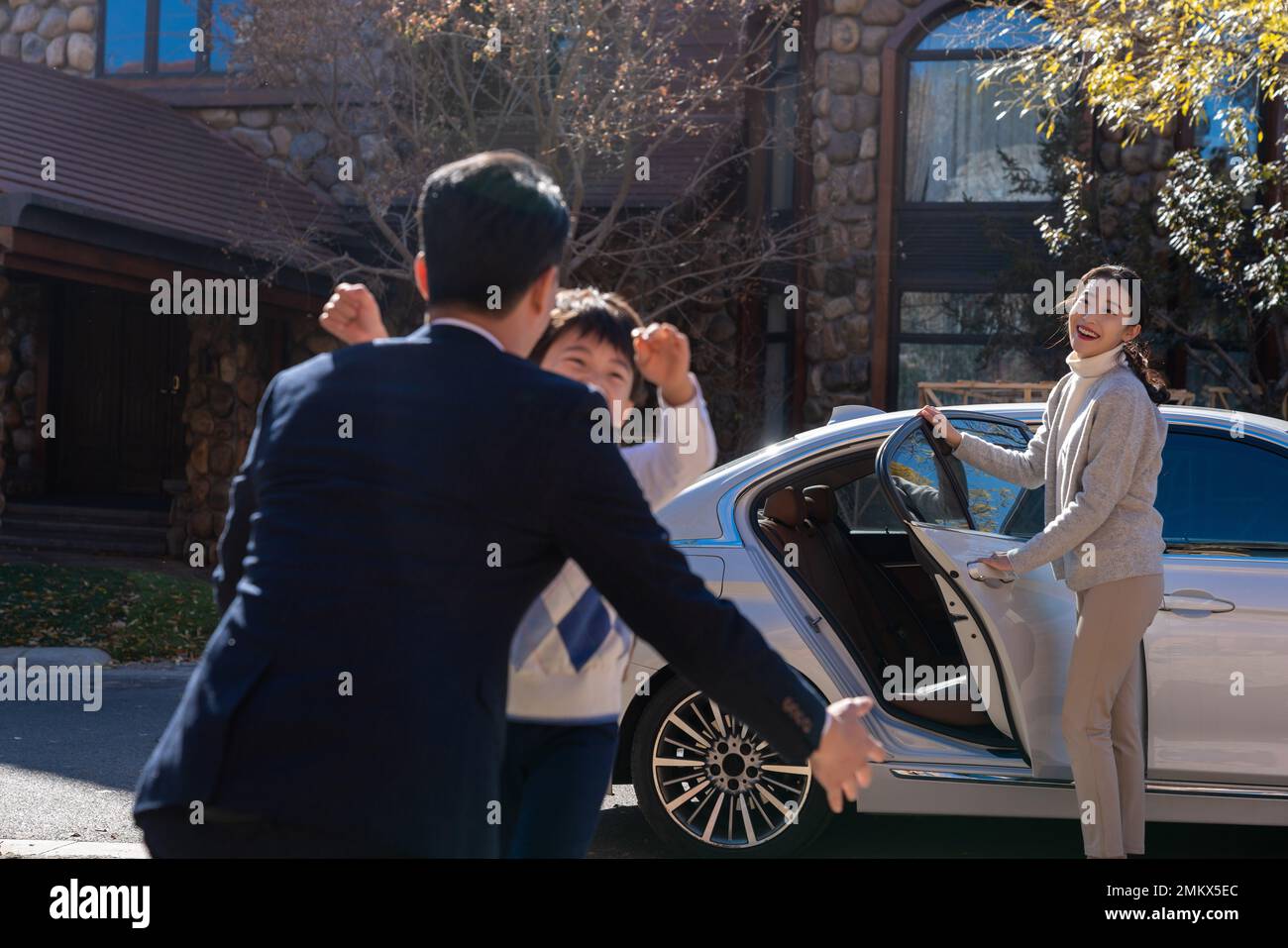 A young couple pick up the kids from school Stock Photo - Alamy