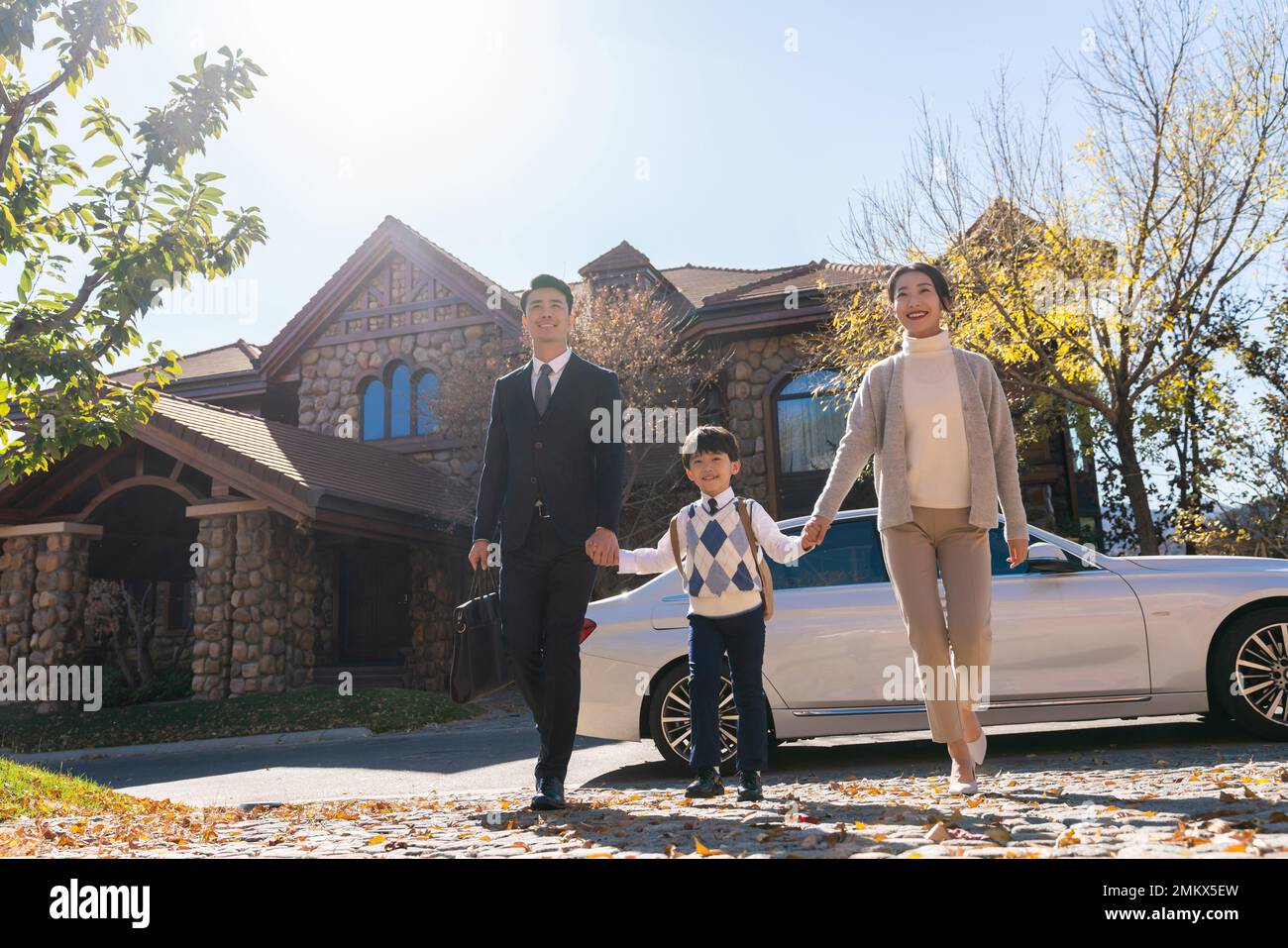 A young couple pick up the kids from school Stock Photo - Alamy
