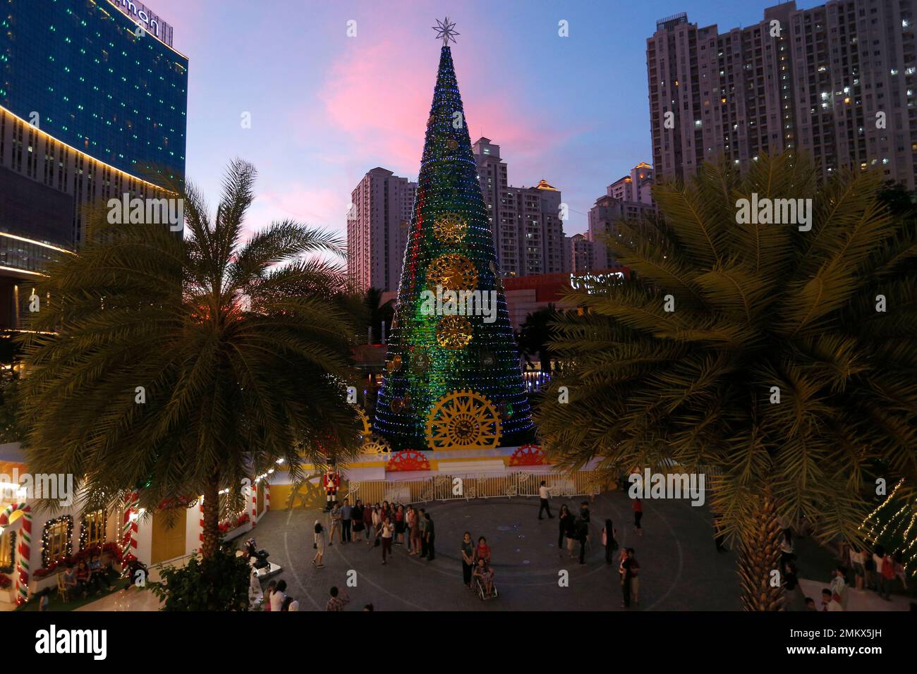 Visitors look at a giant Christmas tree displayed to celebrate the ...
