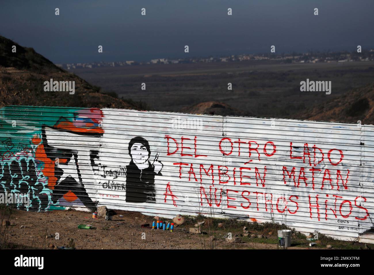 The U.S. border wall carries the Spanish message: "On the other side ...