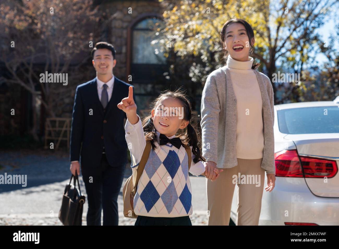 A young couple pick up the kids from school Stock Photo - Alamy