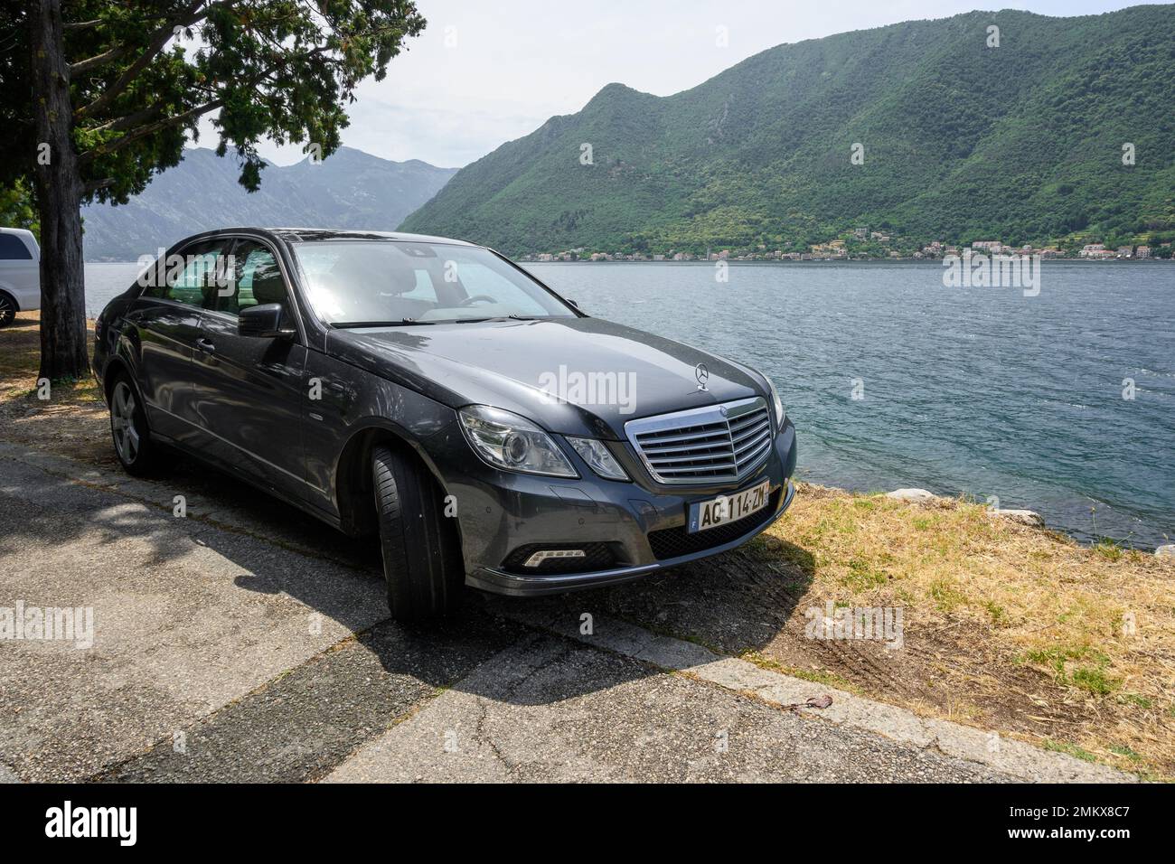 Perast, Montenegro - June , 2022 Mercedes Benz car parked on the coast ...