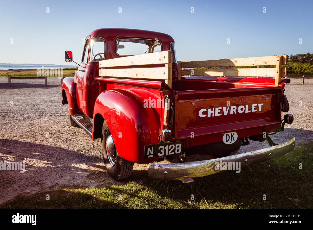 Rear side view of an old red Chevrolet 3100 Pickup Classic Car in a car ...