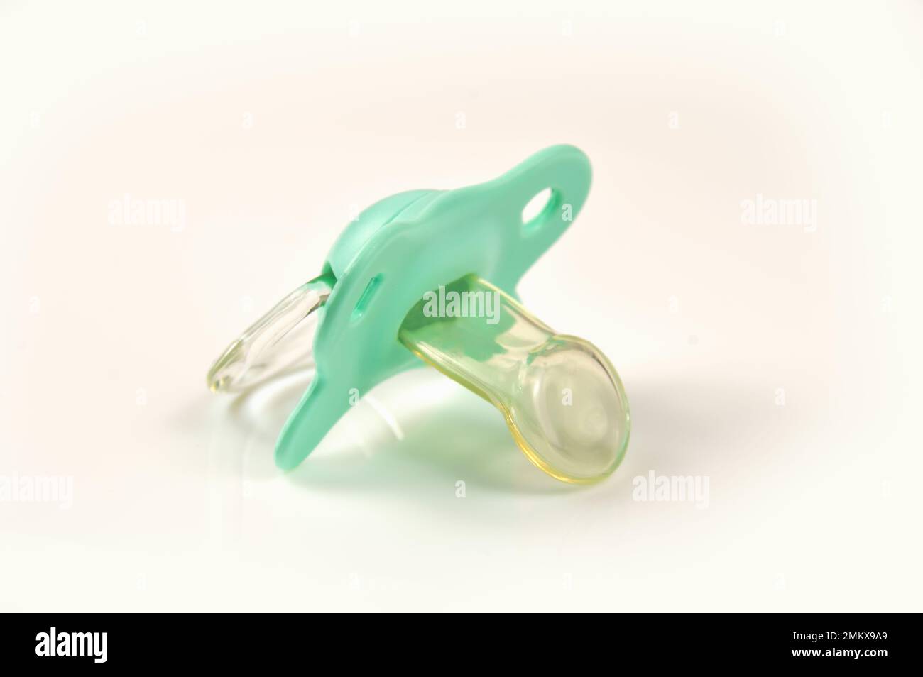 Green baby's pacifier isolated on white background Stock Photo - Alamy