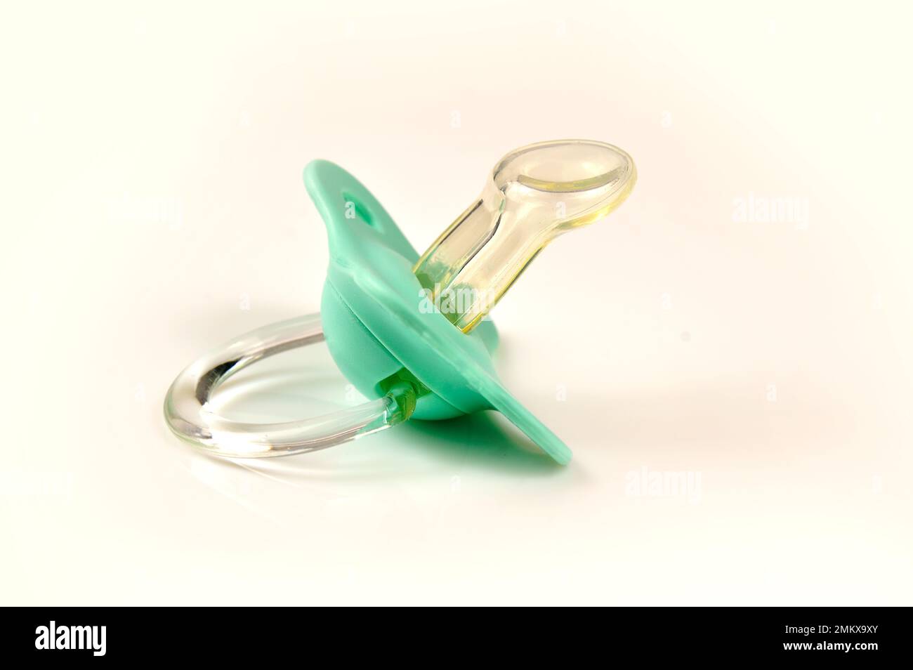Green baby's pacifier isolated on white background Stock Photo - Alamy