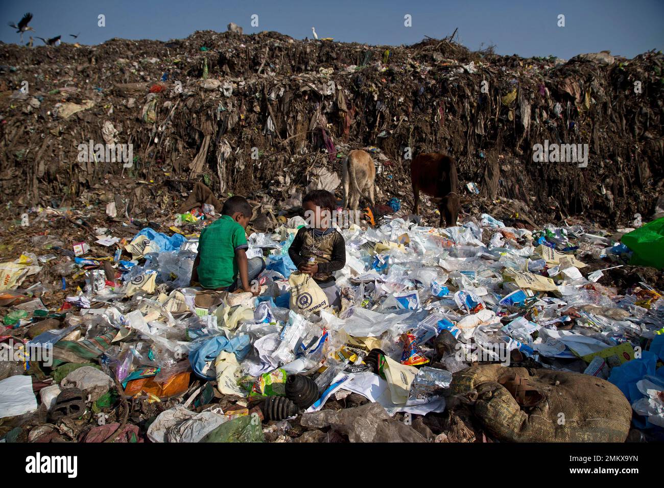 In this Monday, Dec. 10, 2018 photo, Indian children play at a garbage ...