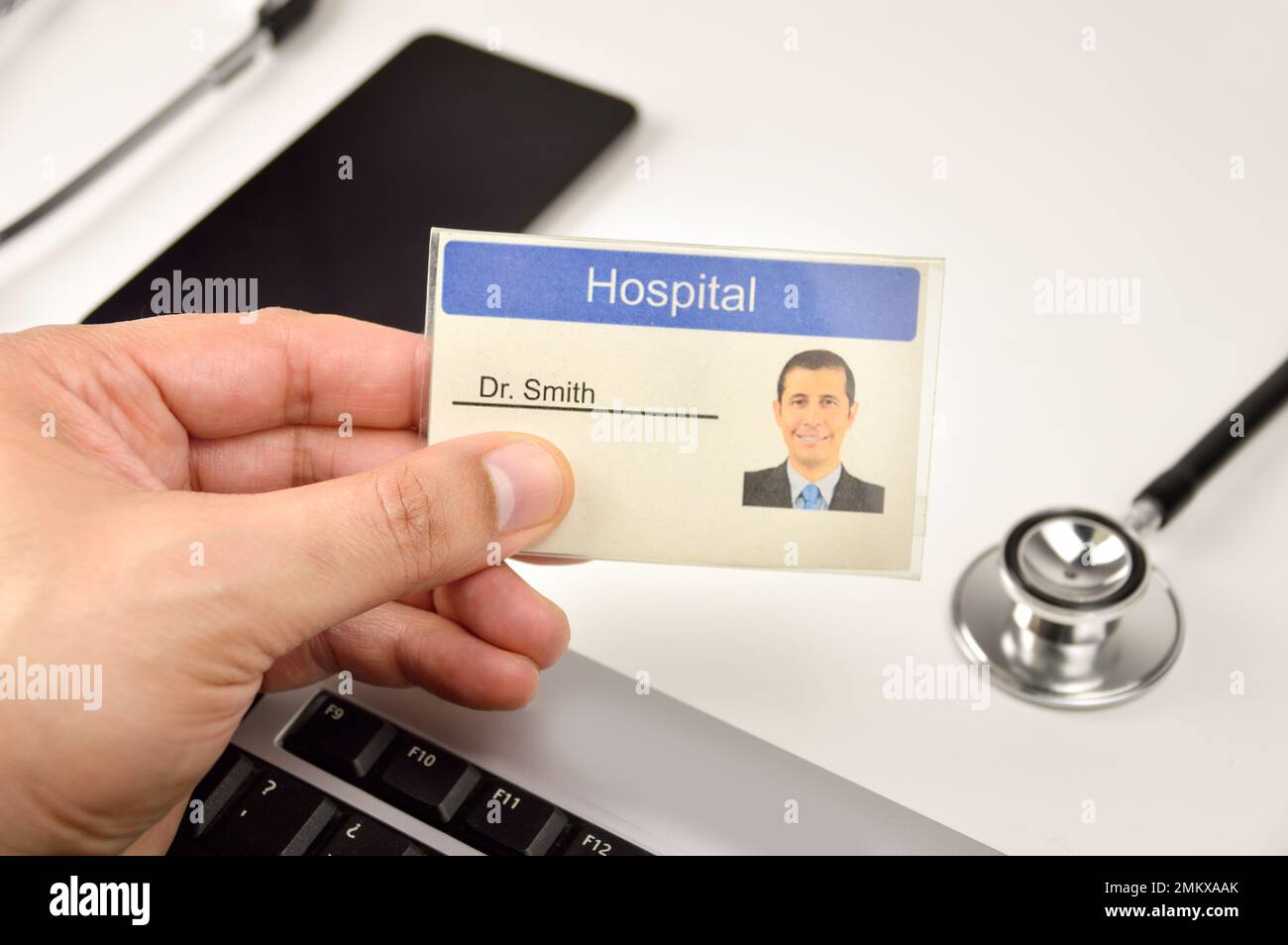 Shot of a hand doctor holding up a identification doctor sign at ...