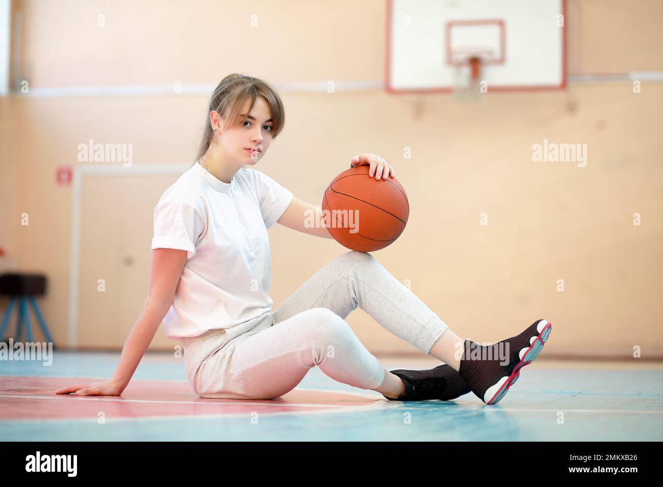 Girl young student in the gym playing a basketball Stock Photo - Alamy