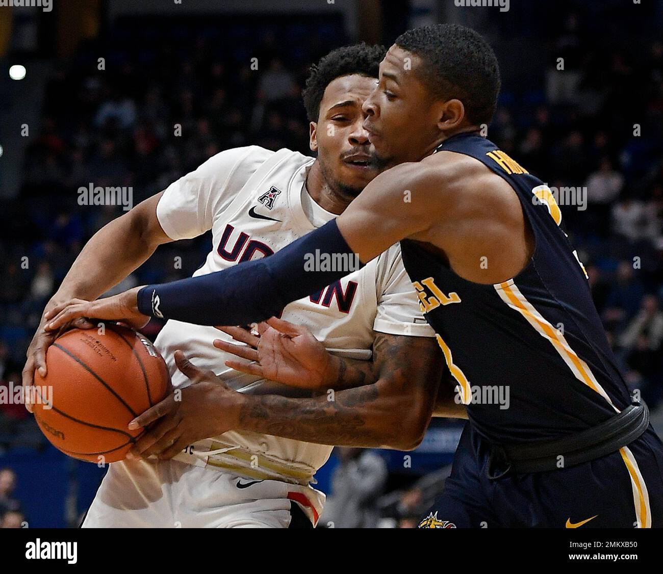 Drexel's Troy Harper, right, pressures Connecticut's Jalen Adams, left ...