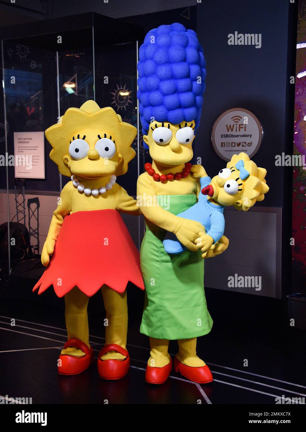 Costumed character Lisa Simpson, left, Marge Simpson and Maggie Simpson ...