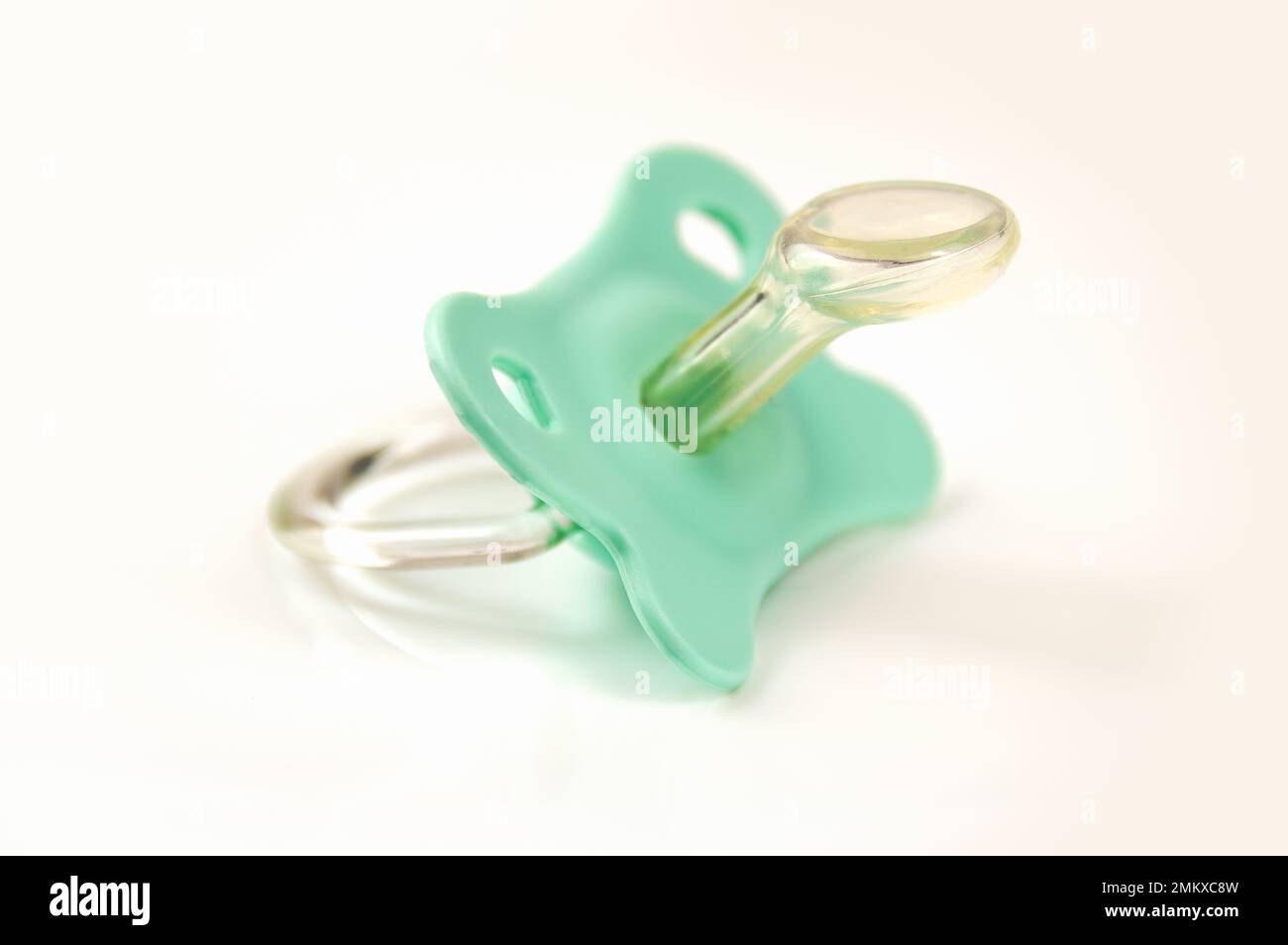 Green baby's pacifier isolated on white background Stock Photo - Alamy