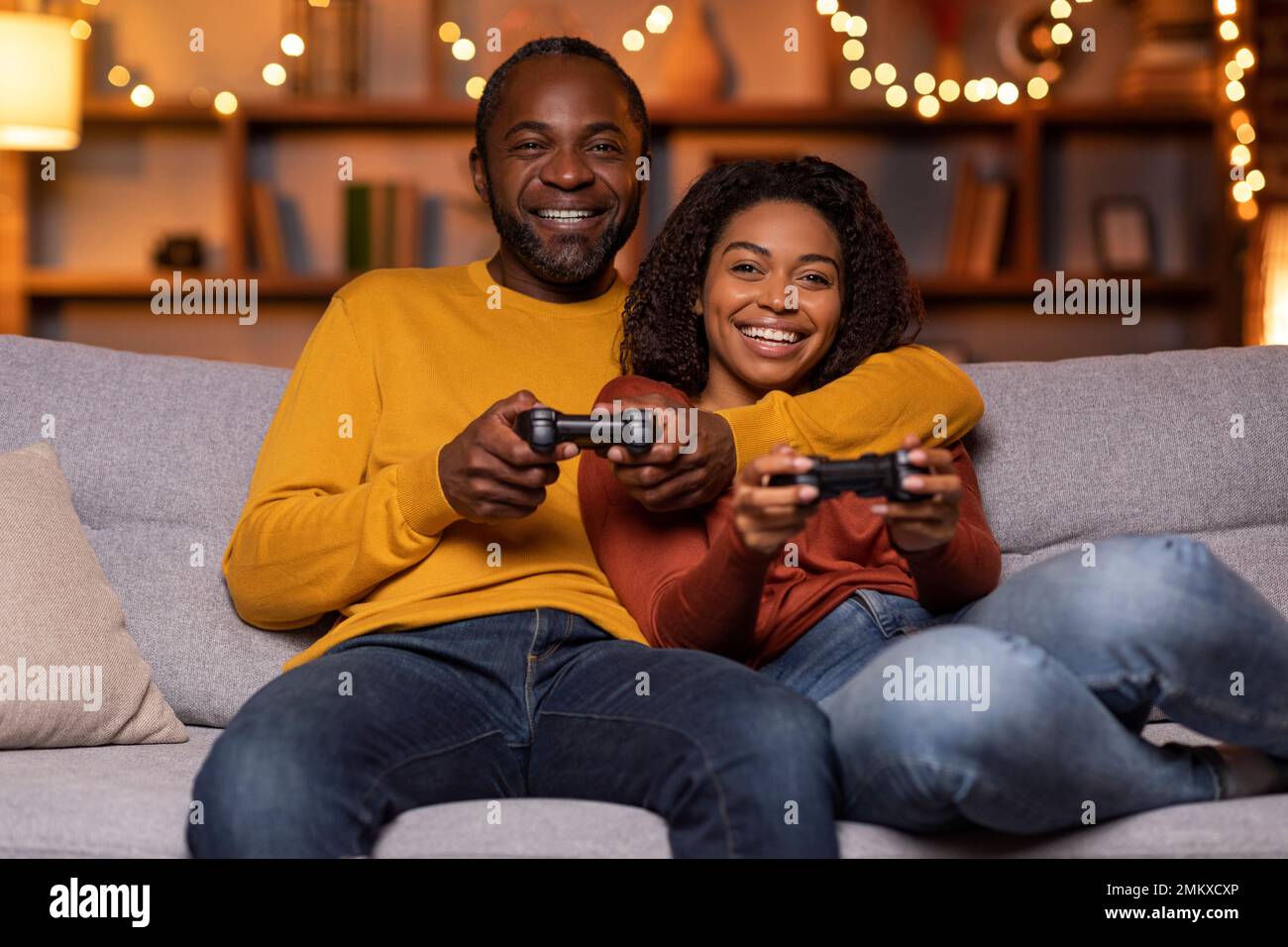 Happy black lovers playing video games at home Stock Photo - Alamy