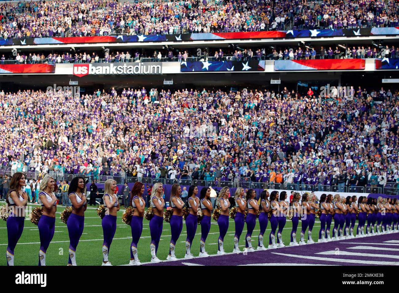 The Minnesota Vikings cheerleaders stand during the national anthem at ...