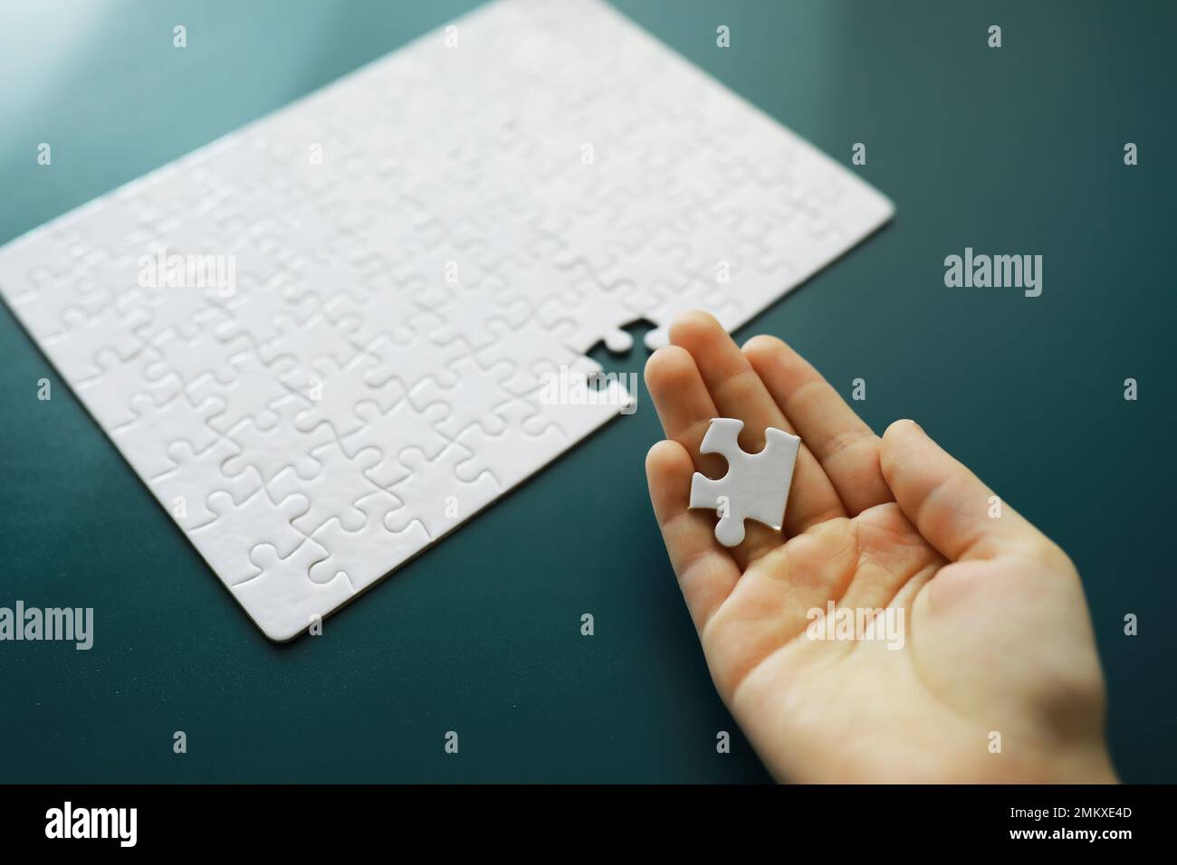 Intellectual puzzles. The puzzle empty. The hand puts together puzzle ...