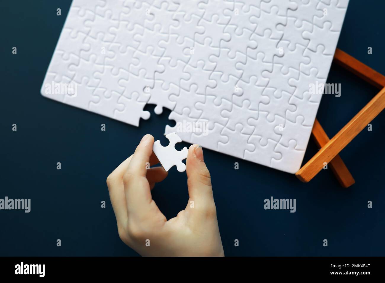 Intellectual puzzles. The puzzle empty. The hand puts together puzzle ...