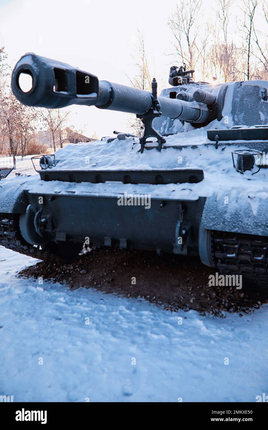 Military tank in a row. Battle tank in the snow on the roadside of ...