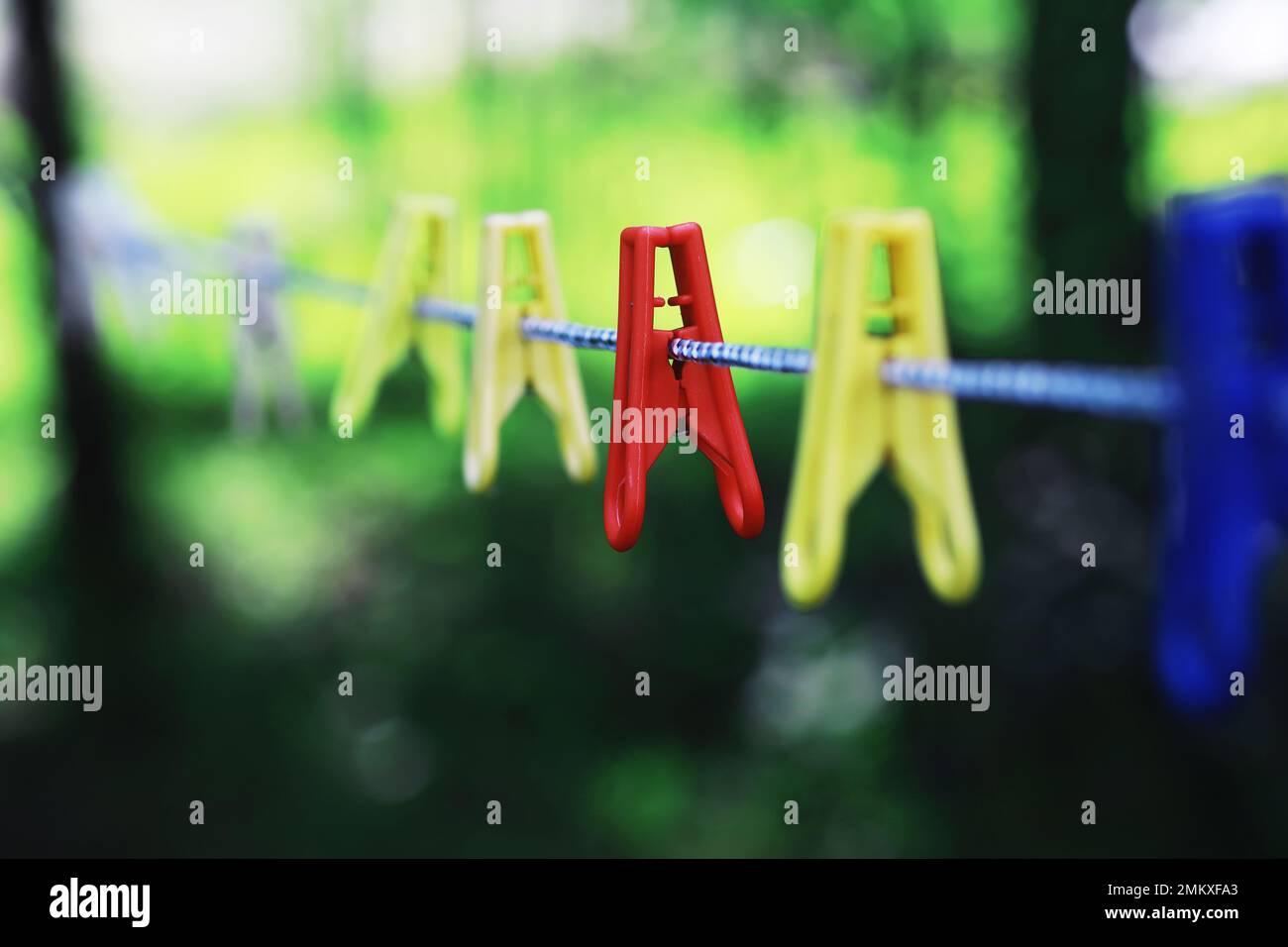 Clothespins on a clothesline in summer. Dry clothes outside. Clothes on ...