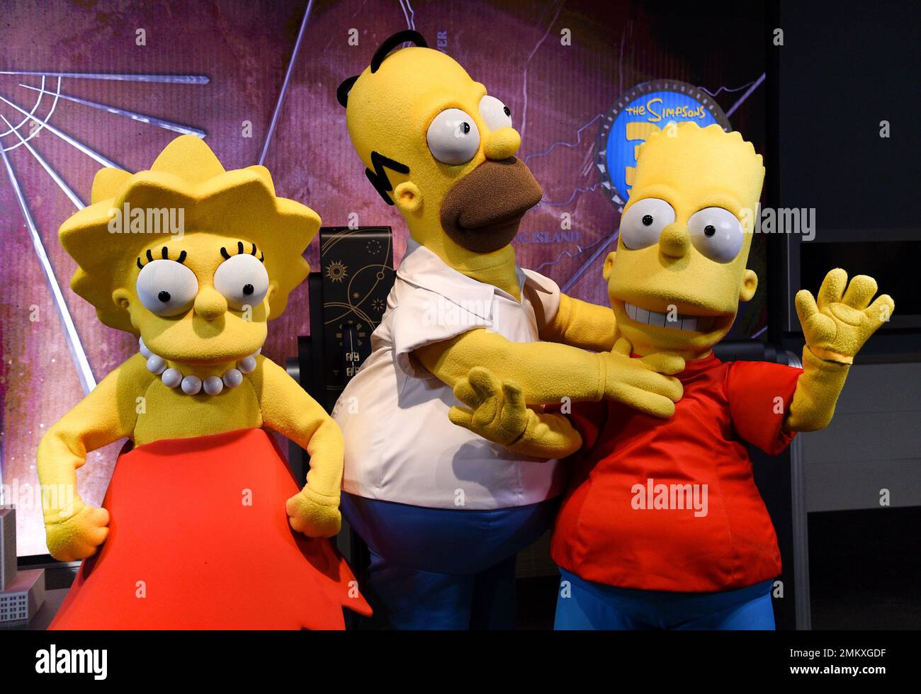 Costumed characters Lisa Simpson, left, Homer Simpson and Bart Simpson ...