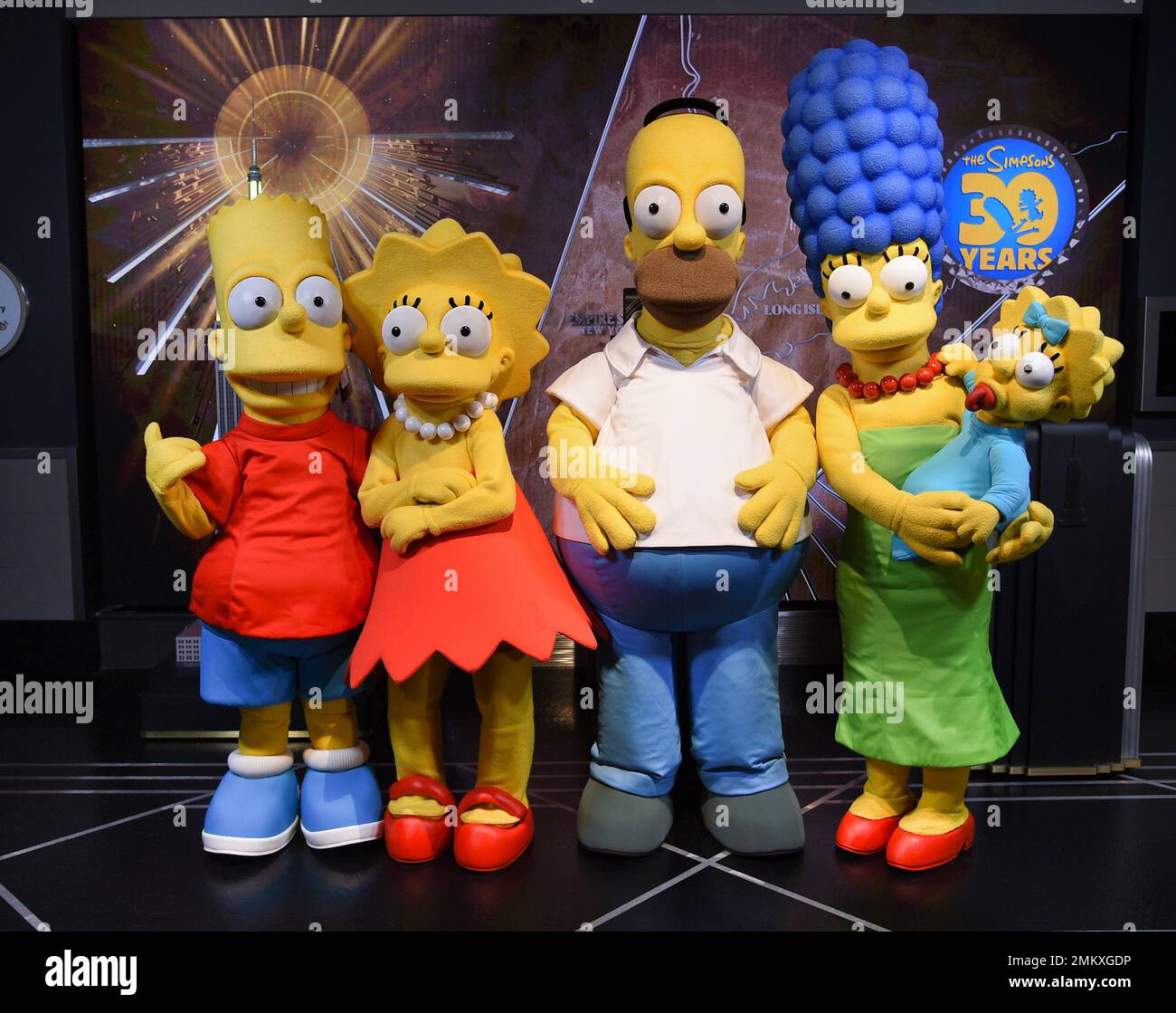 Costumed characters Lisa Simpson, left, Homer Simpson, Marge Simpson ...